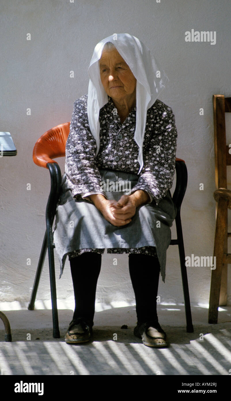 AN AGED GREEK WOMAN SITE IN THE HEAT WITH HER THOUGHTS,ON THE ISLAND OF ...