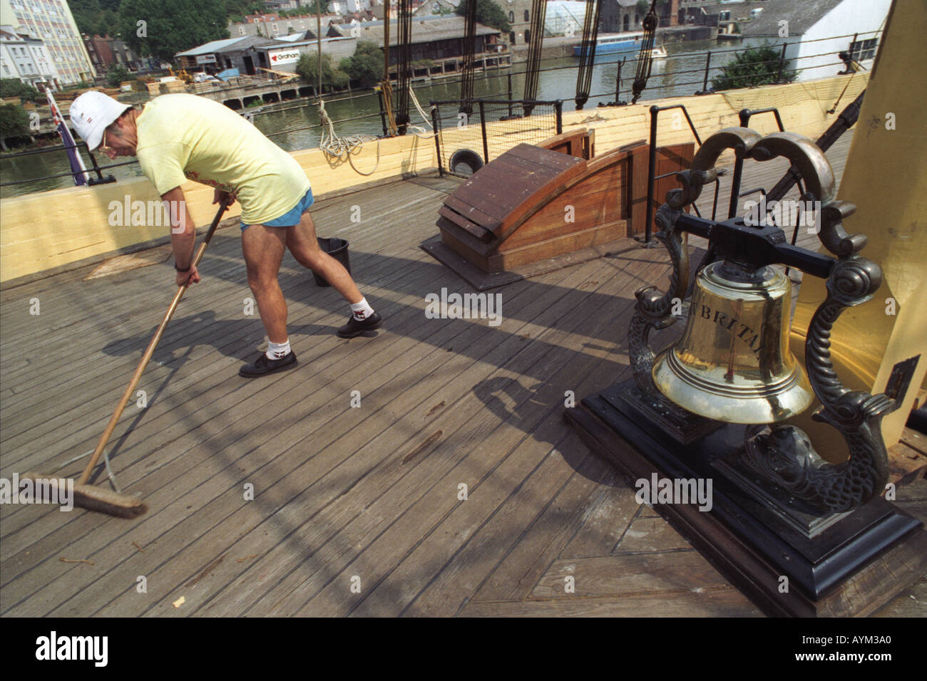 Volunteer swabbing down deck of SS Great Britain built by Victorian ...