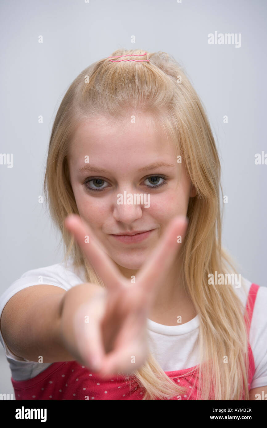 Teenage girl makes V sign Stock Photo - Alamy