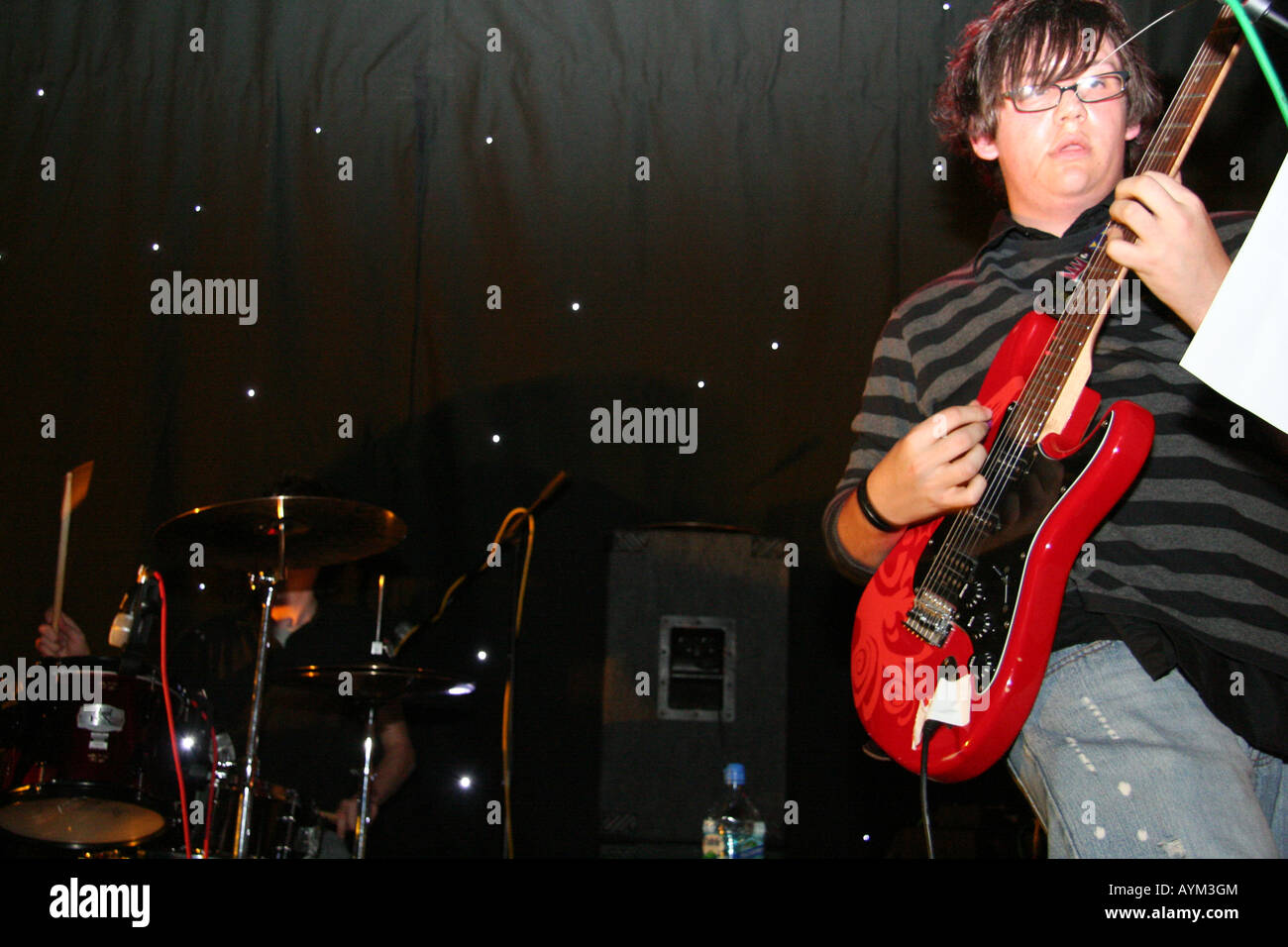 Young bespectacled rock guitarist at his first gig Stock Photo - Alamy