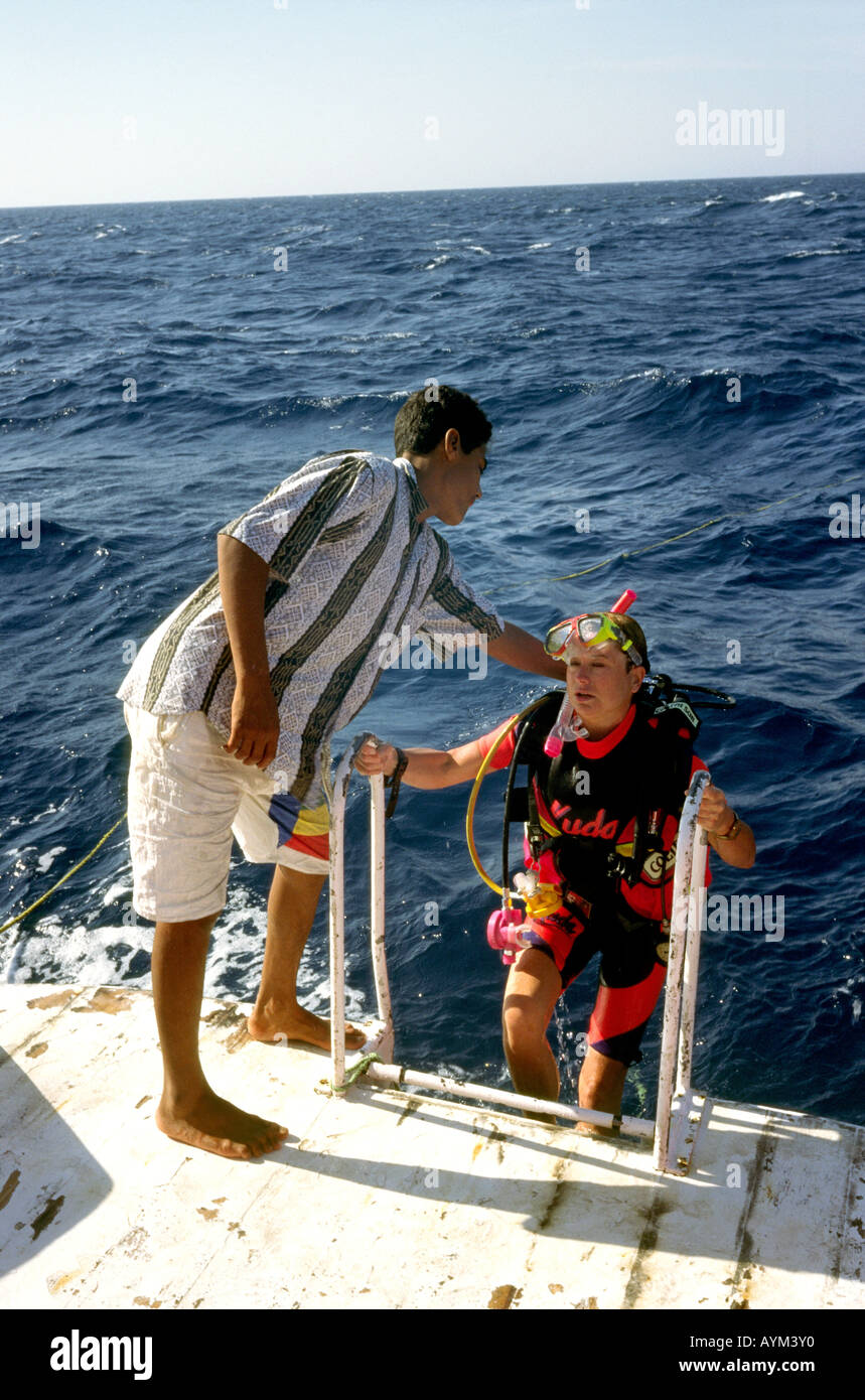 Egypt Red Sea female diver boarding boat after dive Stock Photo - Alamy