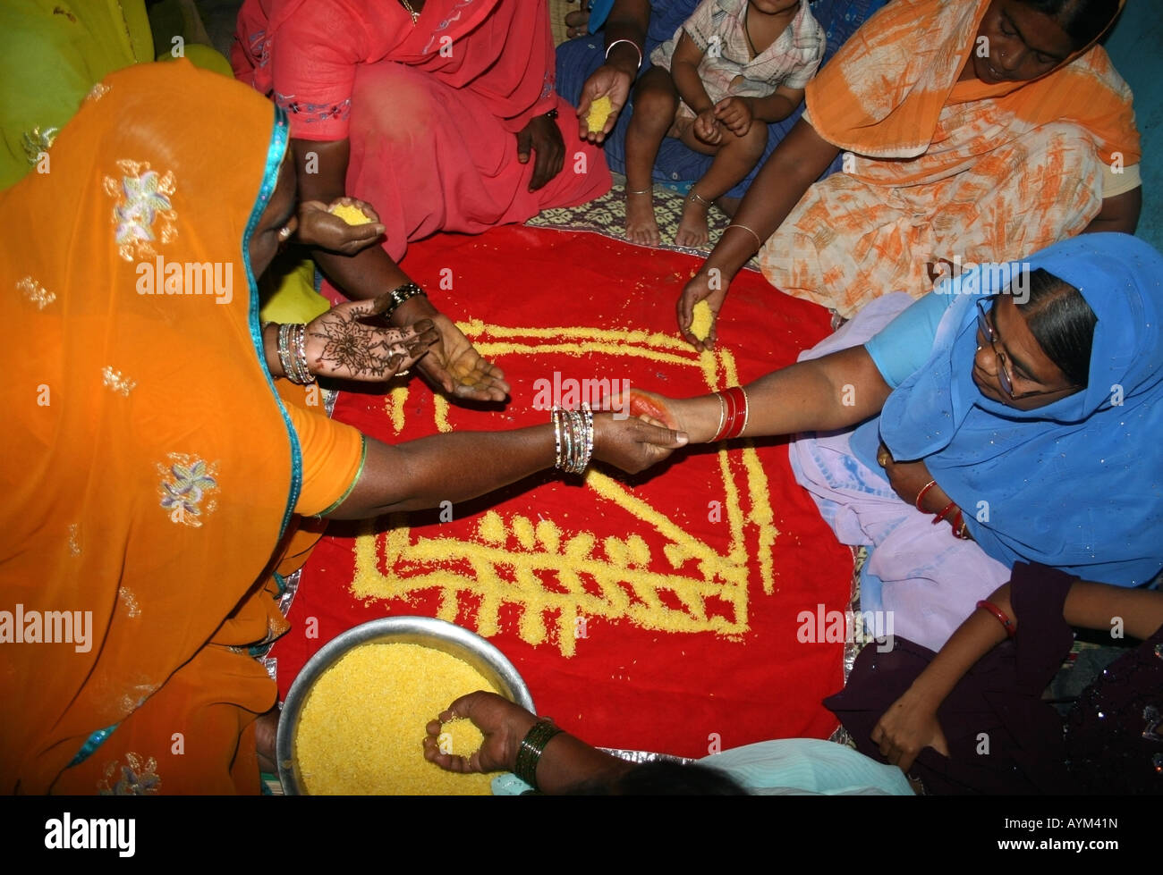 Muslim women make rice patterns for the muslim groom in a ceremony ...