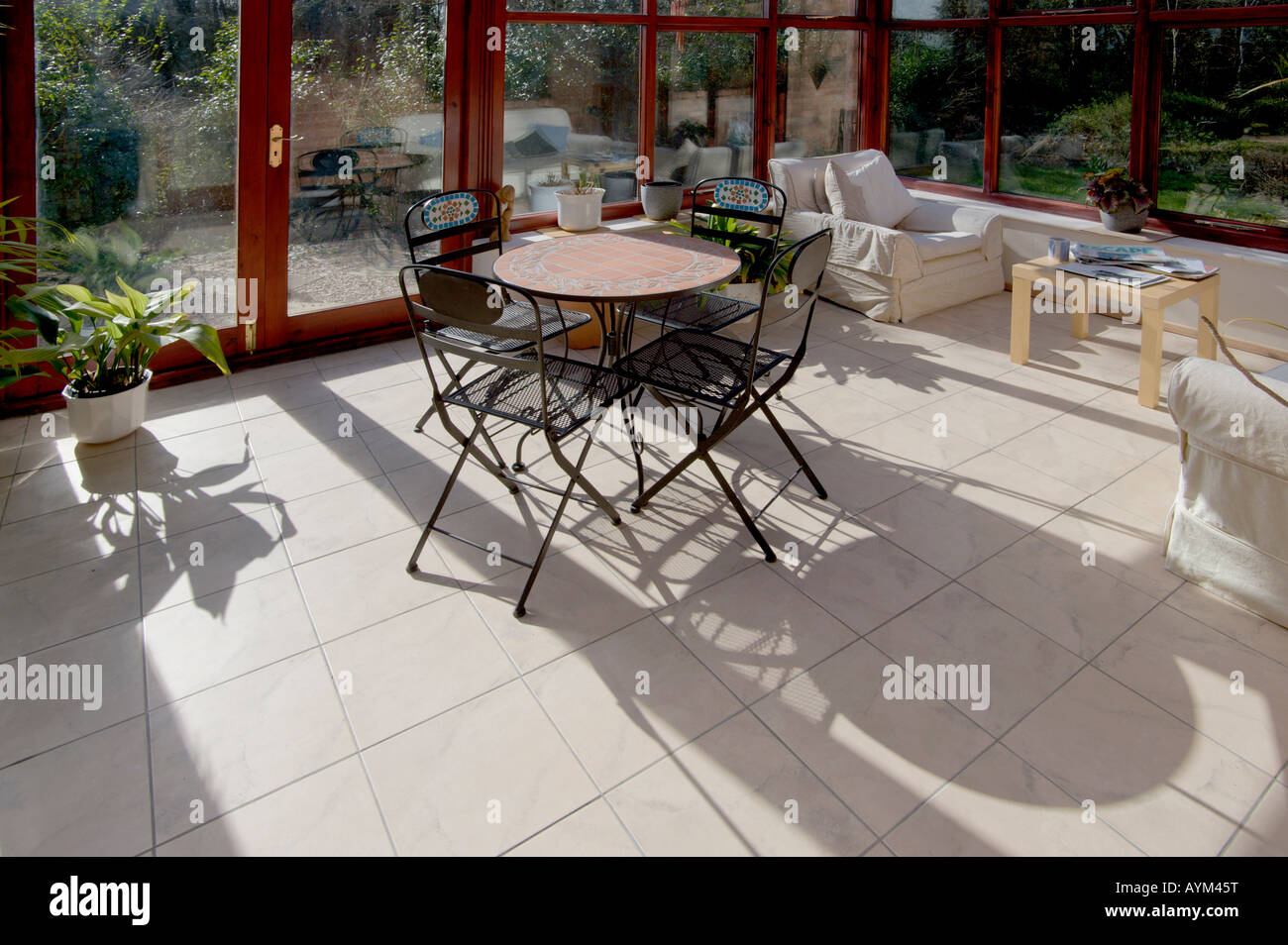 conservatory tables chairs plants room in house next to garden Stock ...