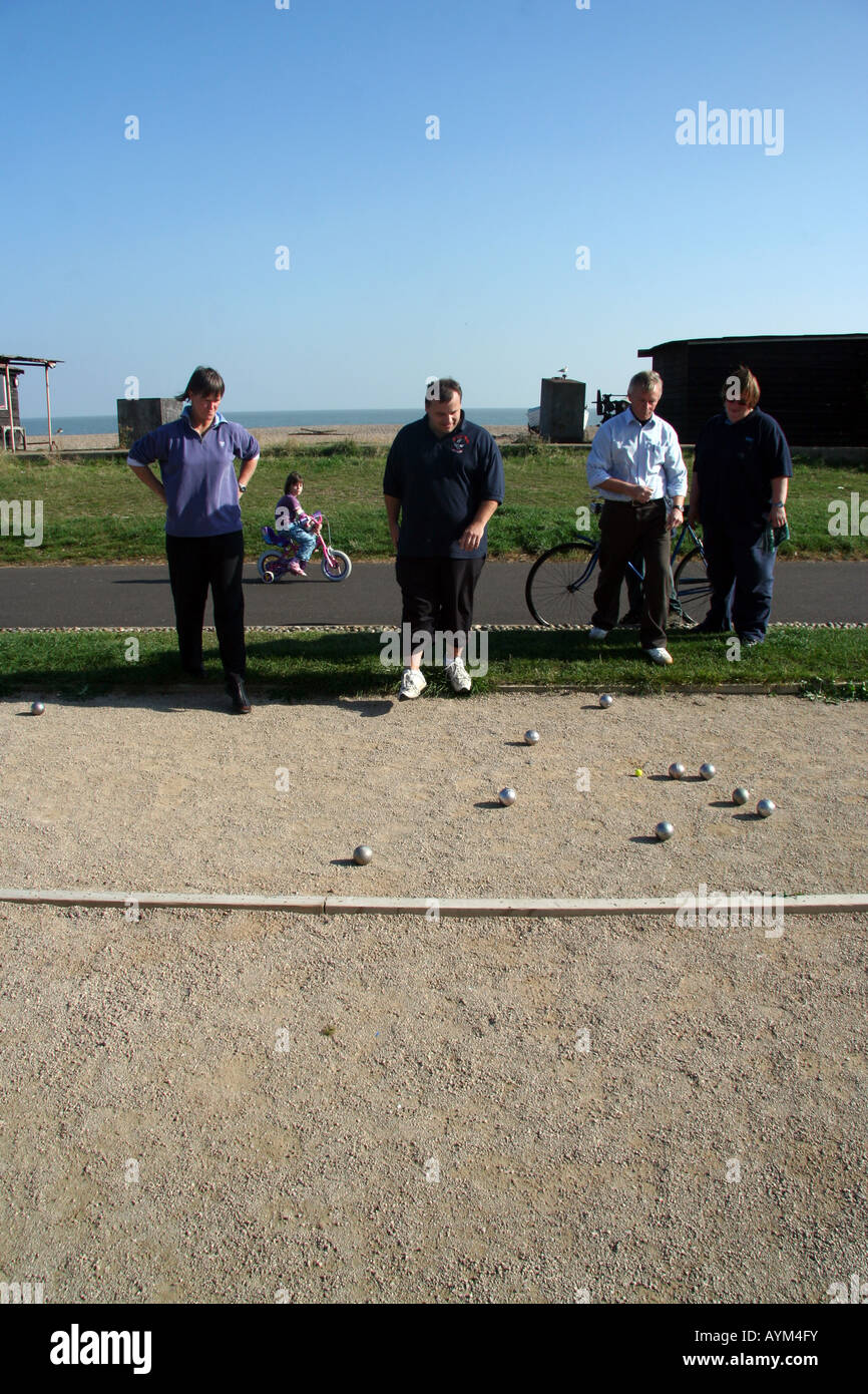 Four people play boule at the seaside Stock Photo - Alamy