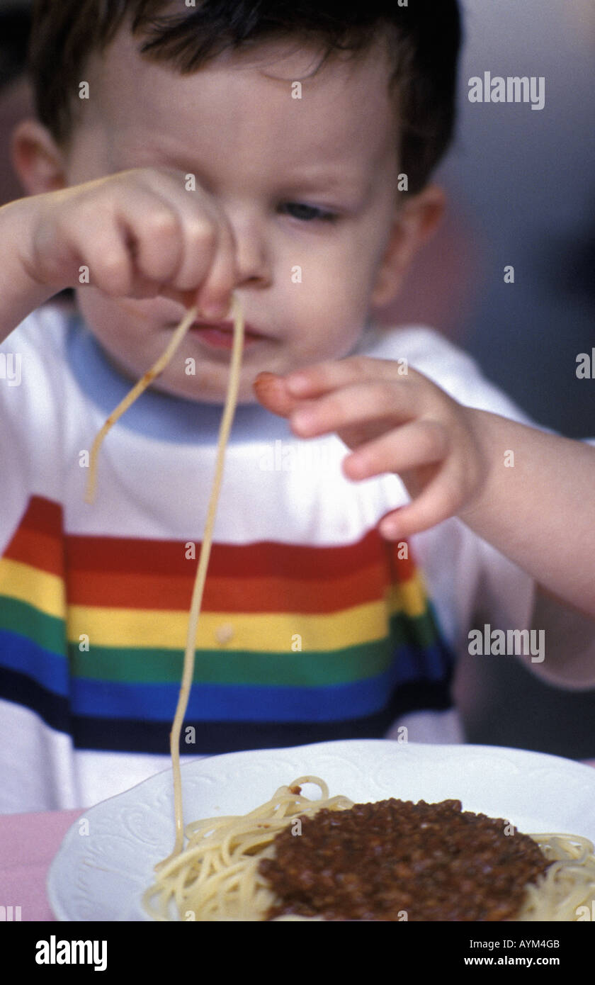 a young boy eating spaghetti bolognese Stock Photo - Alamy