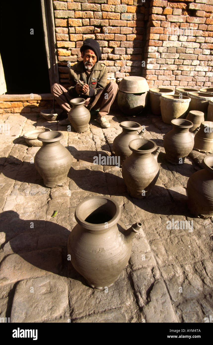 Nepal Thimi crafts pottery man fixing spouts onto greenware pots Stock ...