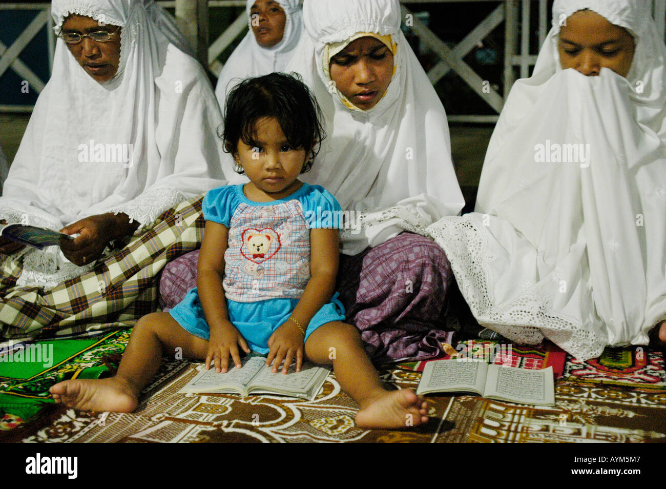 A young muslim girl in Banda Aceh Indonesia with her mother at the ...