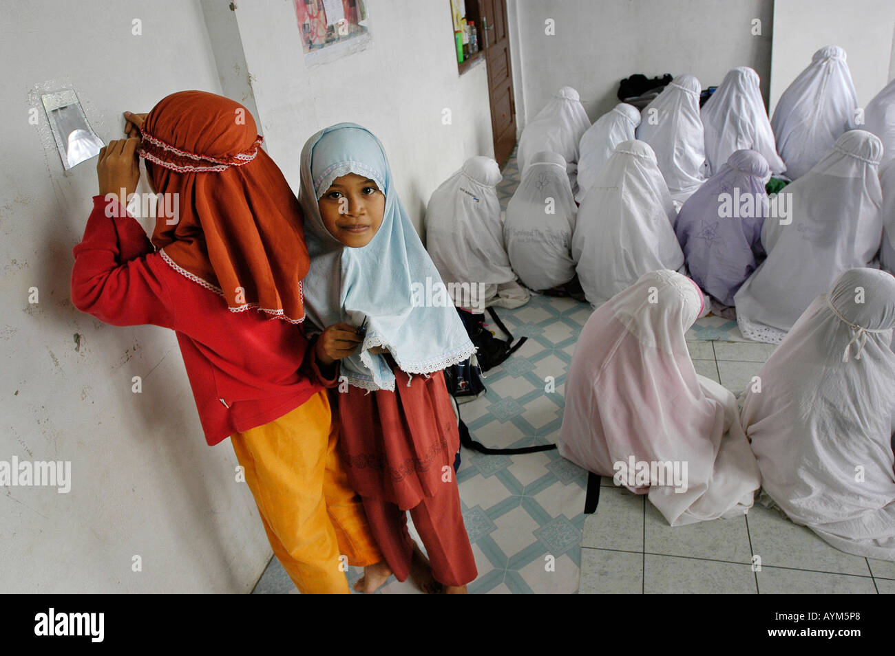 Two young muslim girls in Banda Aceh Indonesia are playing while the ...