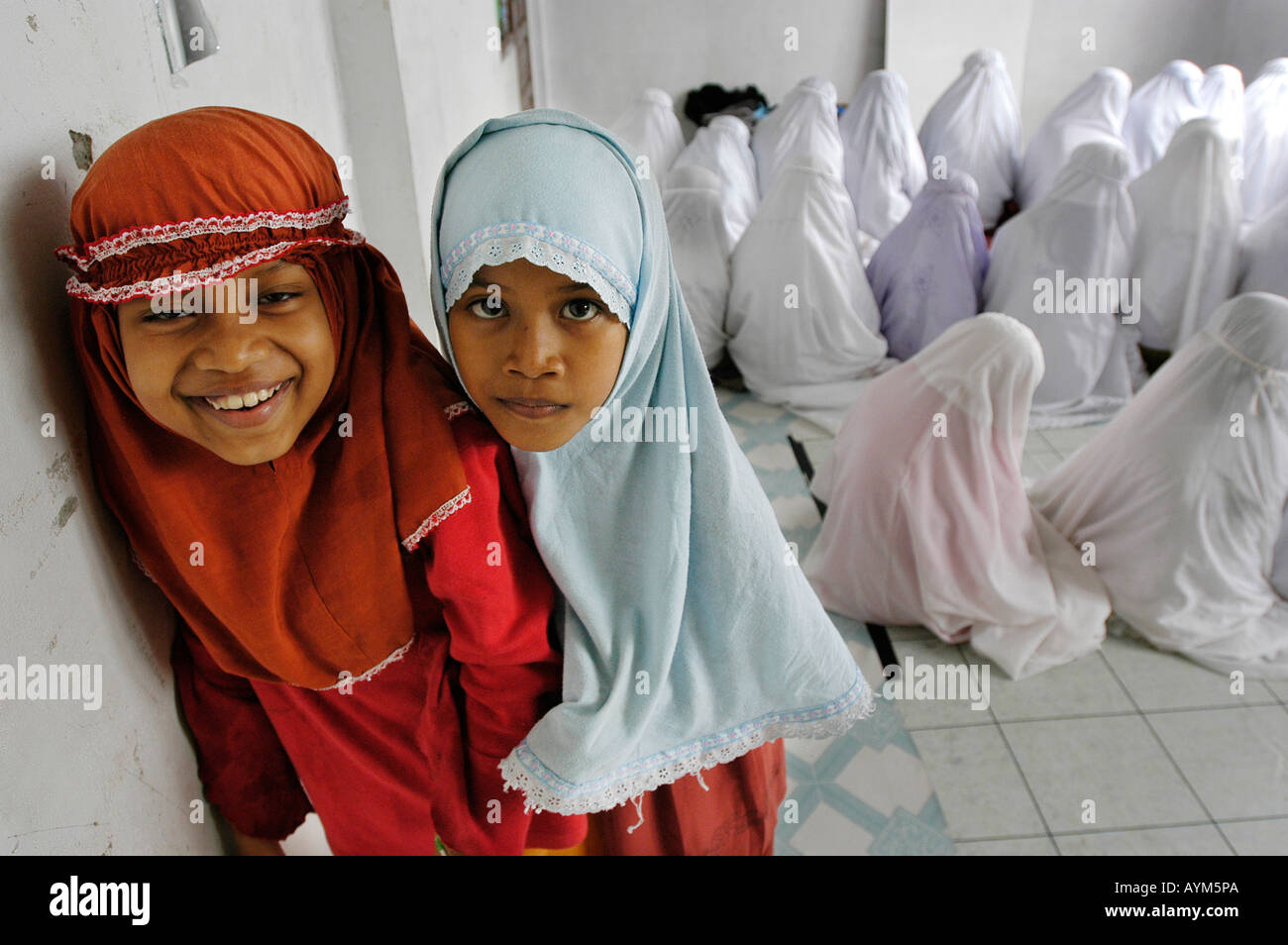 Two young muslim girls in Banda Aceh Indonesia are playing while the ...