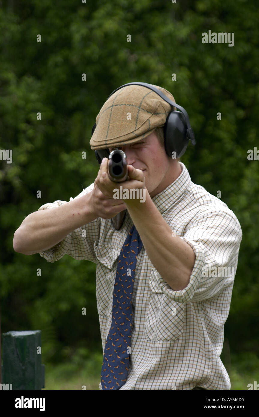 Man pointing shotgun at the camera Stock Photo - Alamy