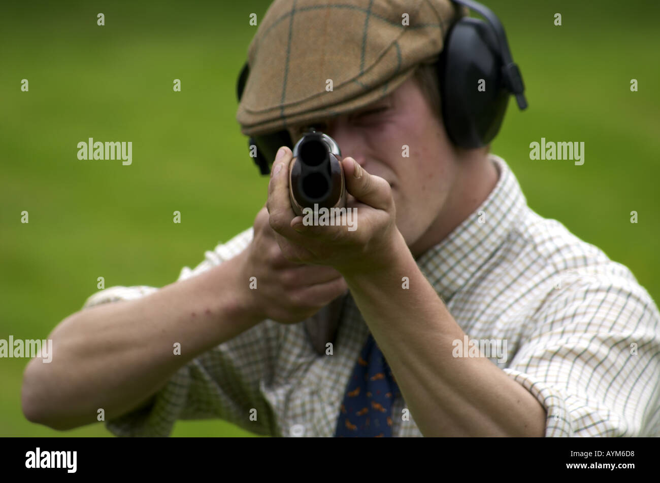 Man pointing shotgun at the camera Stock Photo - Alamy