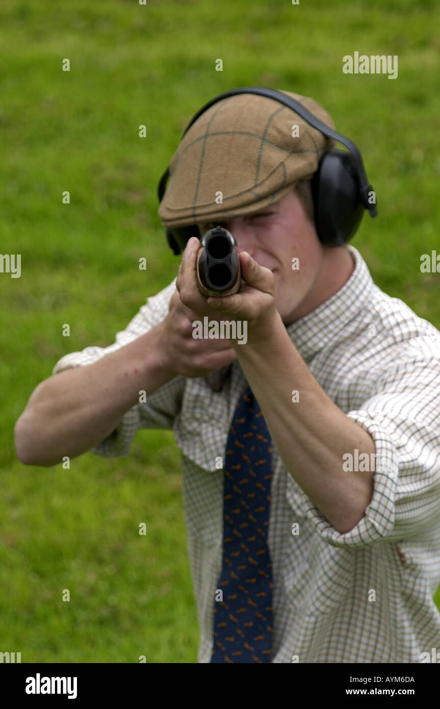 Man pointing shotgun at the camera Stock Photo - Alamy