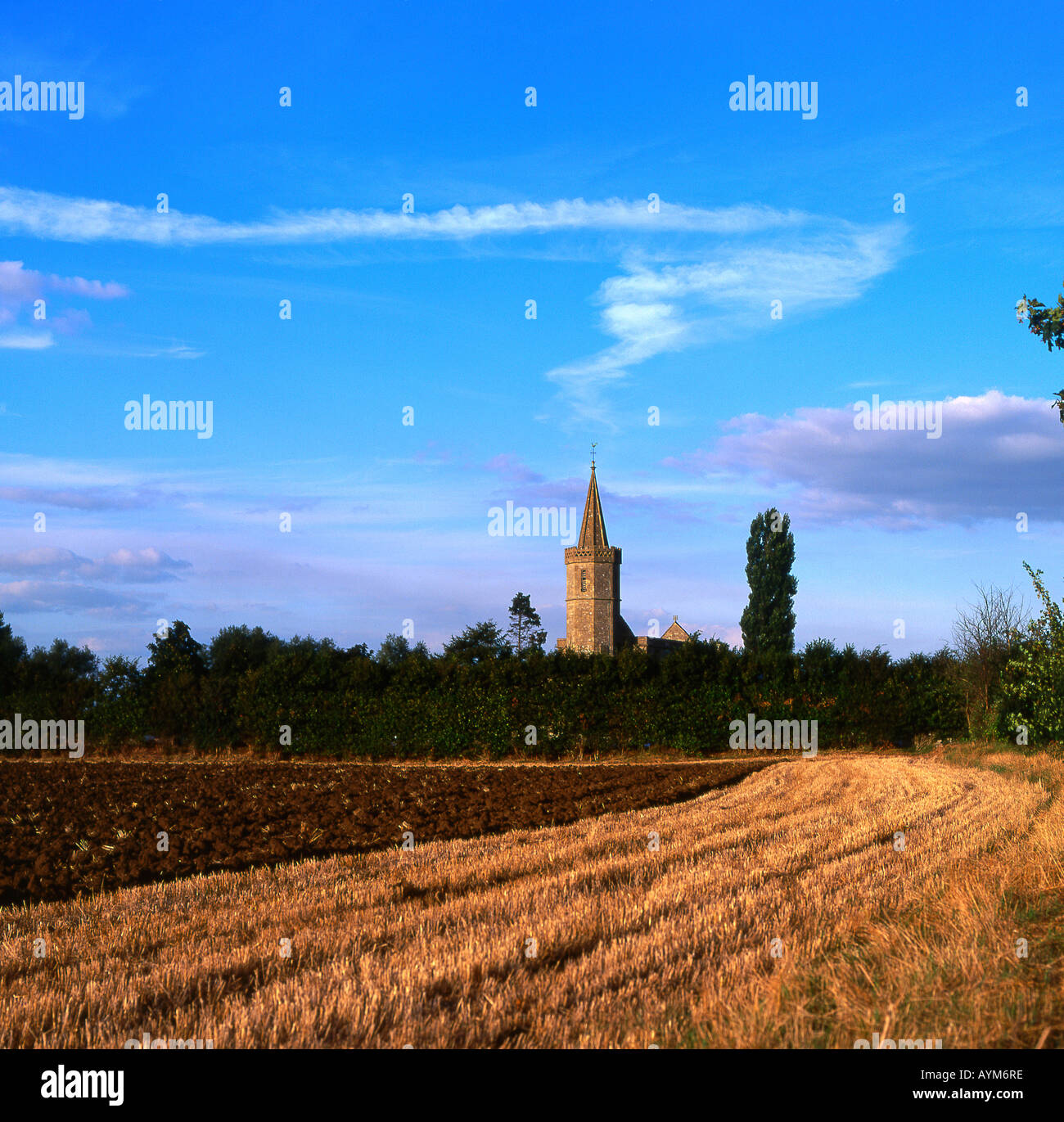 Ploughed field and Saint Giles Church at Standlake in Oxfordshire ...