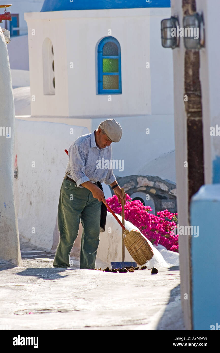 Old man cleaning the street Stock Photo - Alamy