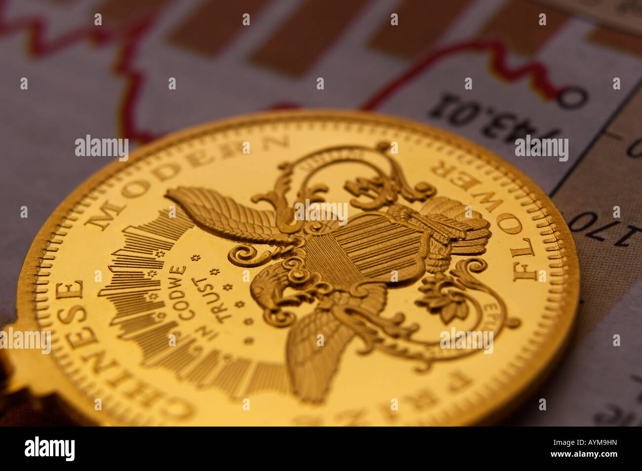 Graphs and gold coin Stock Photo - Alamy