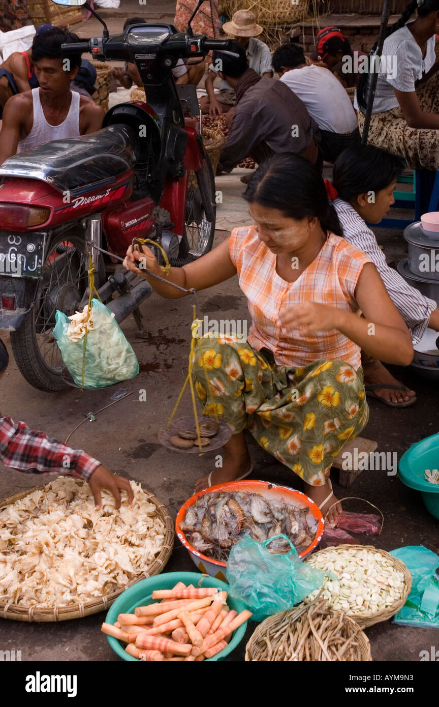 Stock photograph of a vendor with a simple scales in the market at ...
