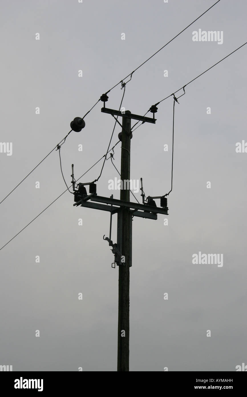 Powerline against a grey stormy sky Stock Photo - Alamy