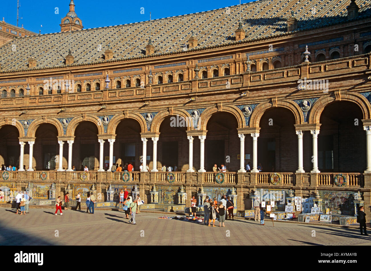 Colonnade and tourists in Plaza de Espana, Seville, Spain Stock Photo ...