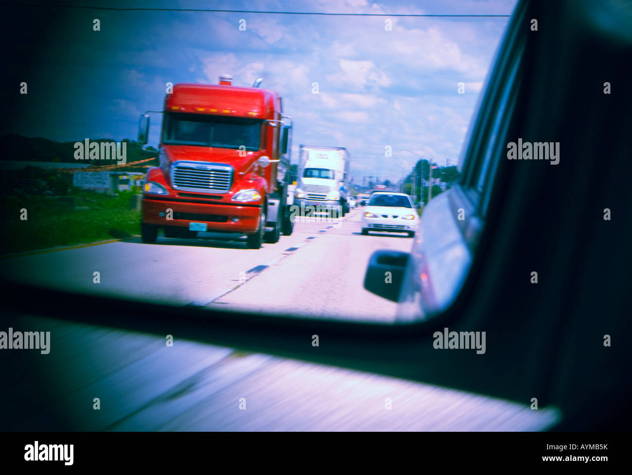 rear view car mirror showing speeding red truck passing car Stock Photo ...