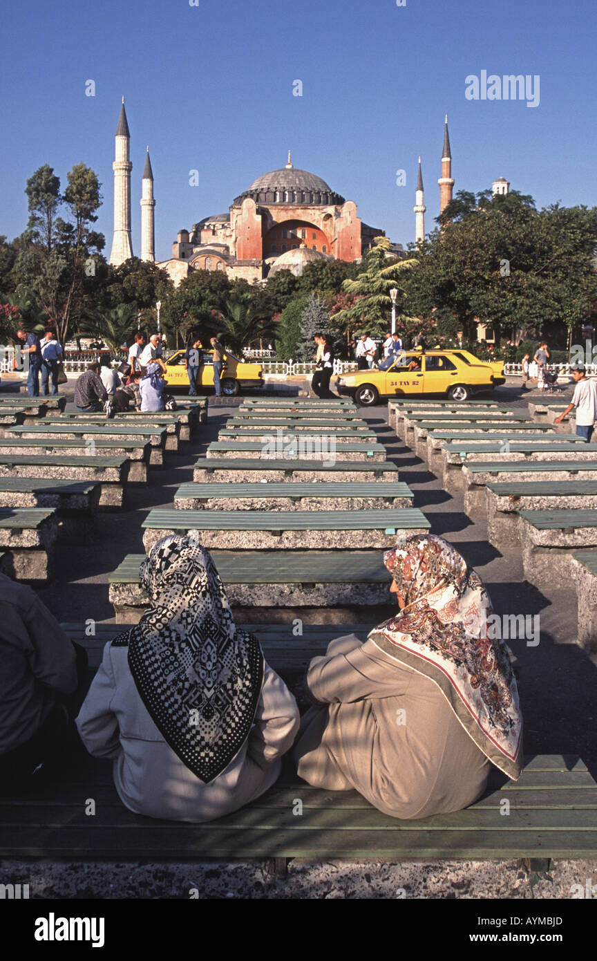 ISTANBUL, TURKEY. Traditionally-dressed Turkish women sitting opposite ...