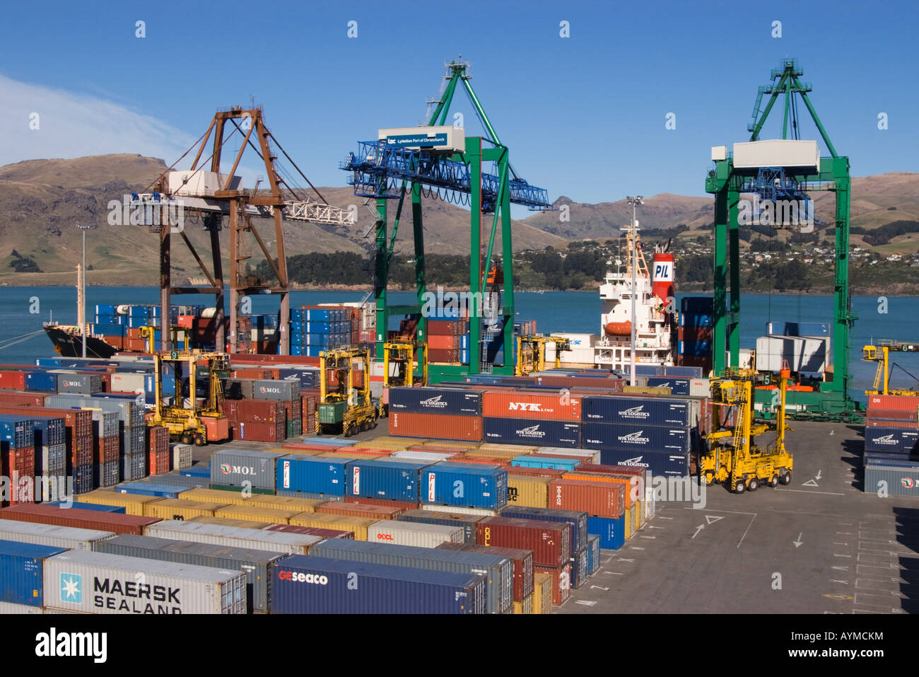 A general view of a container terminal with a ship being worked by 3 ...