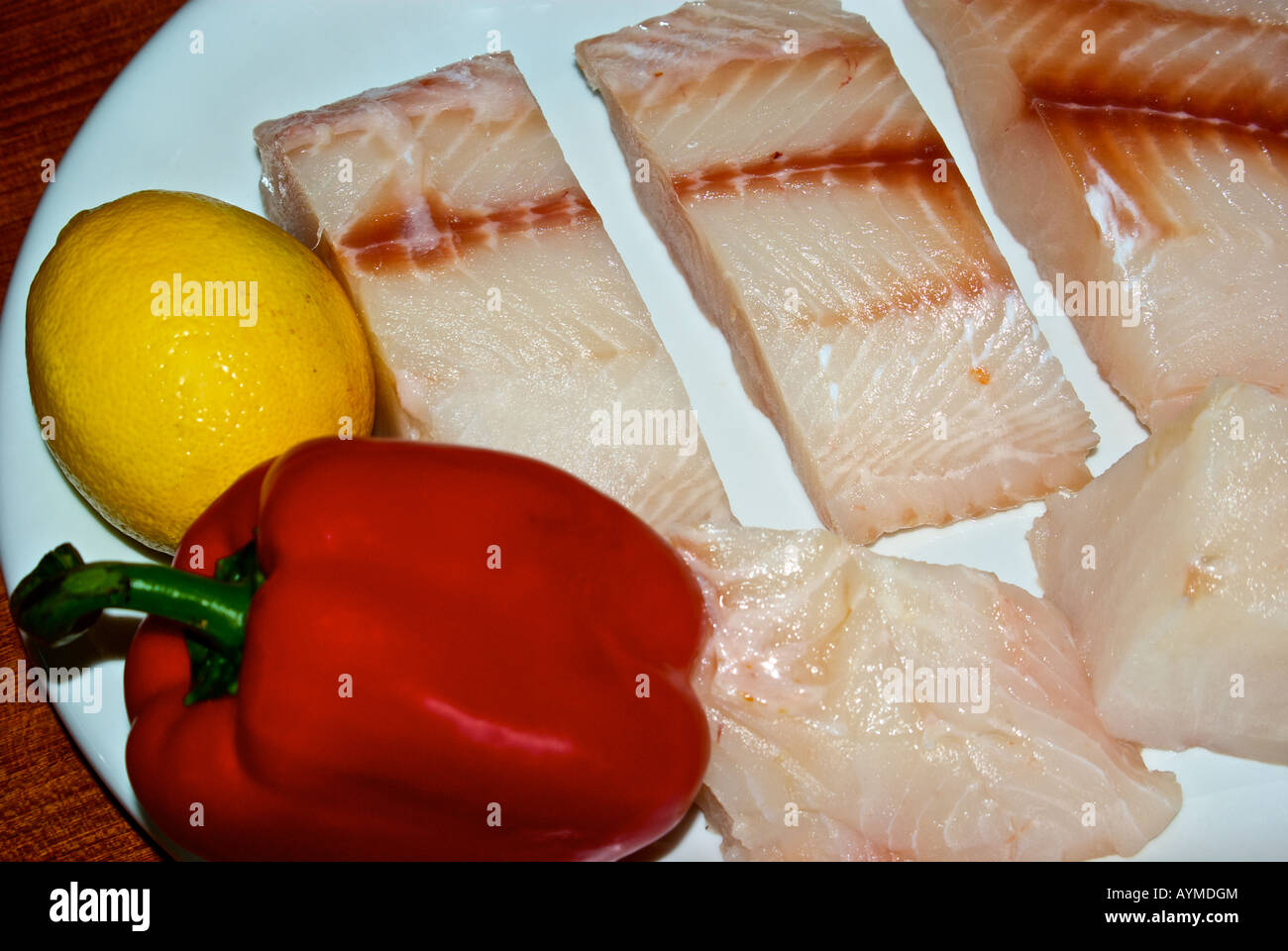 Raw boneless skinless fillet of ling cod cut into pieces for cooking ...