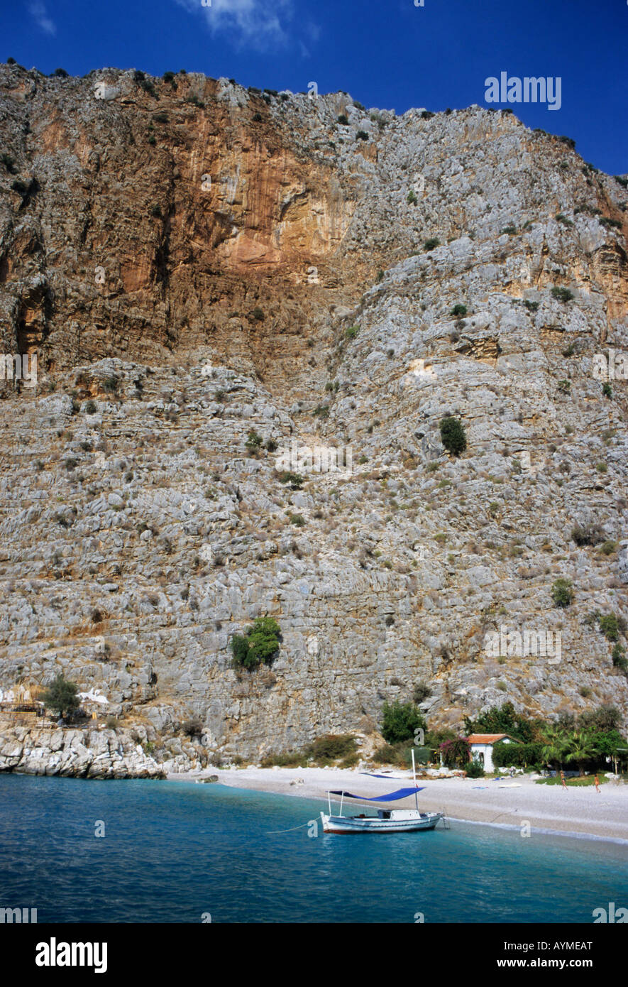 Imposing cliffs of Butterfly Valley tower above the white sand beach ...