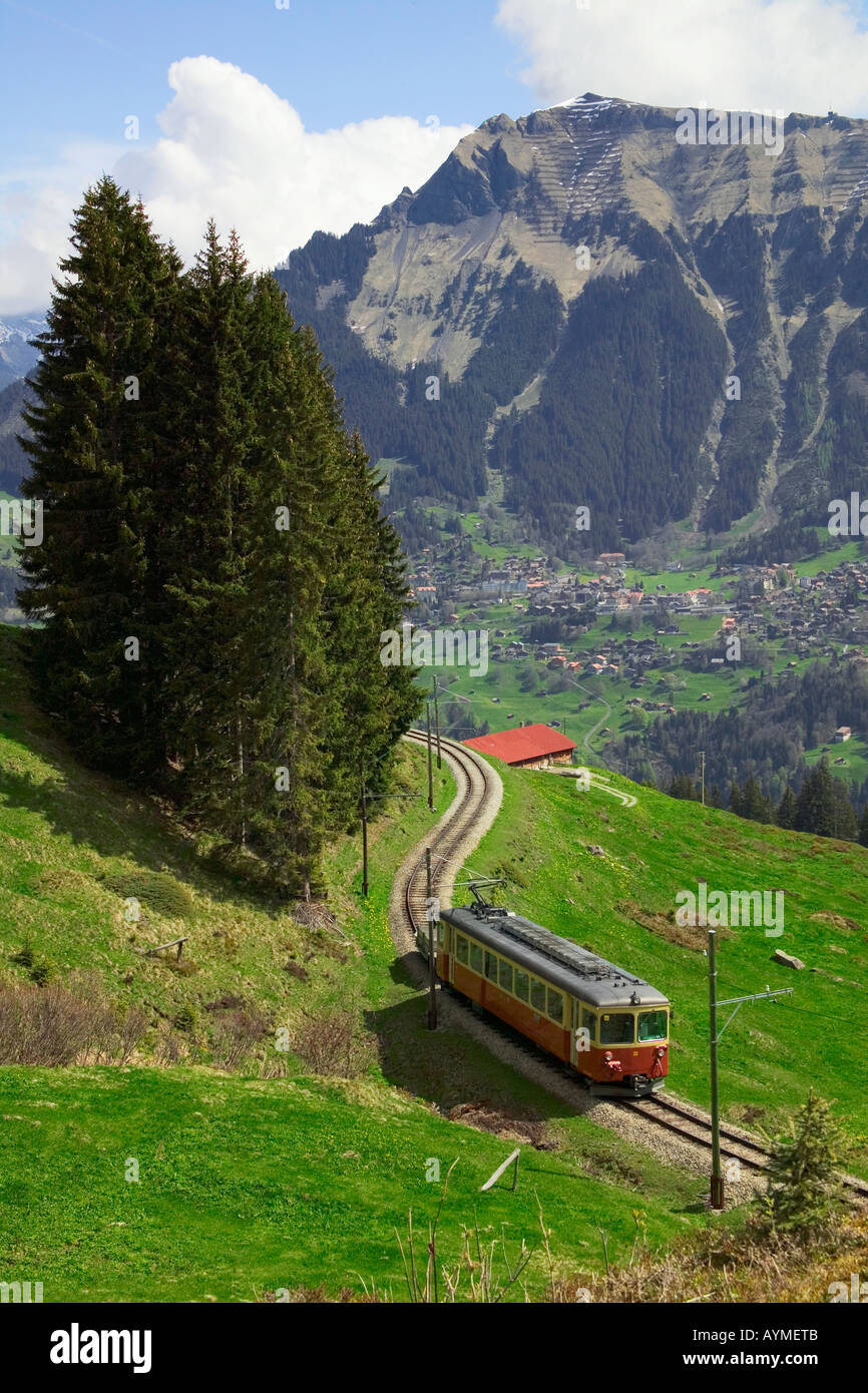 A train approaches Murren, Switzerland in the Swiss Alps overlooking ...