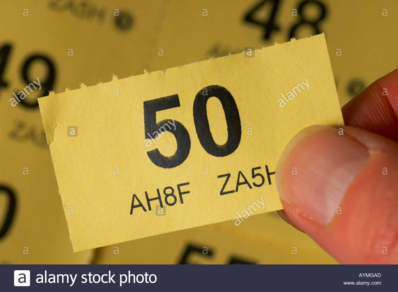 A yellow raffle ticket - fifty Stock Photo - Alamy