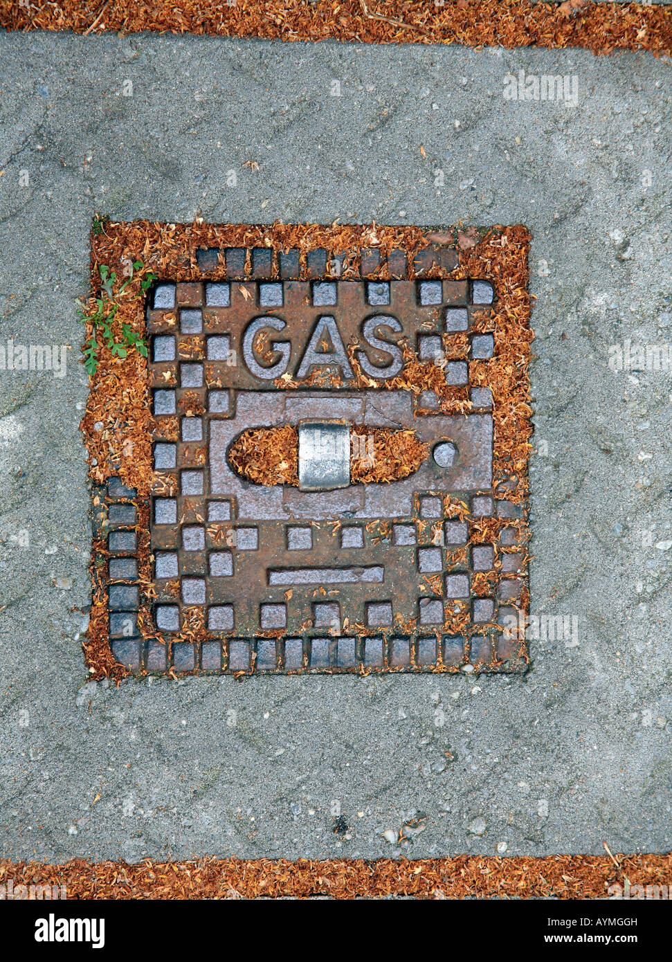 manhole cover set into a street reveals reddish square pattern Stock ...
