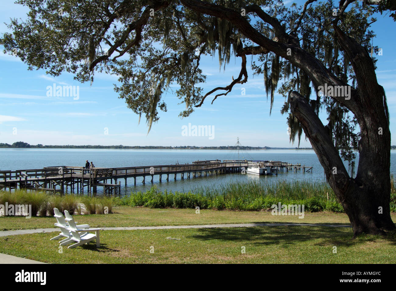 Lake Dora at Mount Dora in central Florida USA.White Adirondack chairs ...