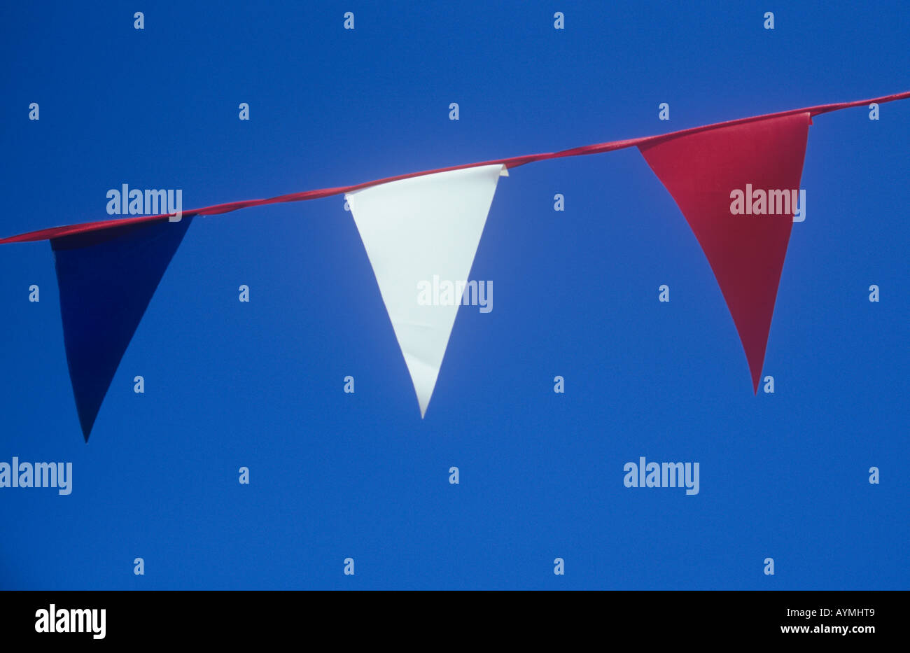 Detail of plastic flag bunting showing blue white and red triangular ...