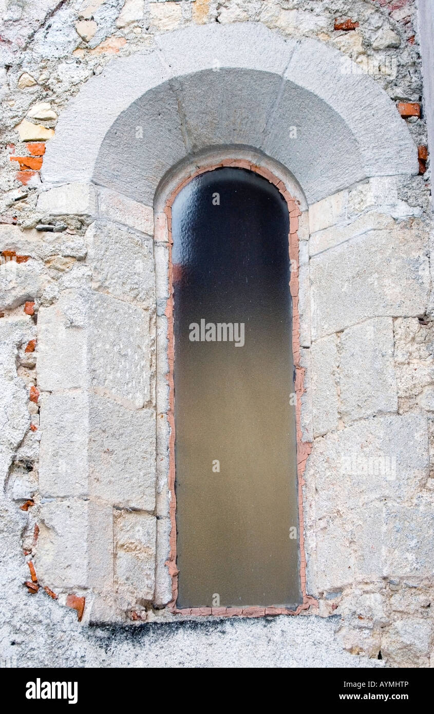 Narrow castle window with glass Stock Photo - Alamy