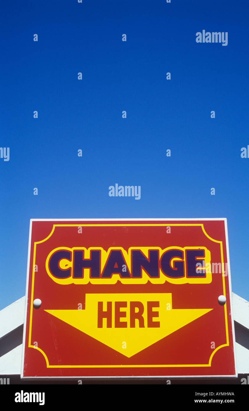 Close up of red yellow and blue sign with downward pointing arrow ...