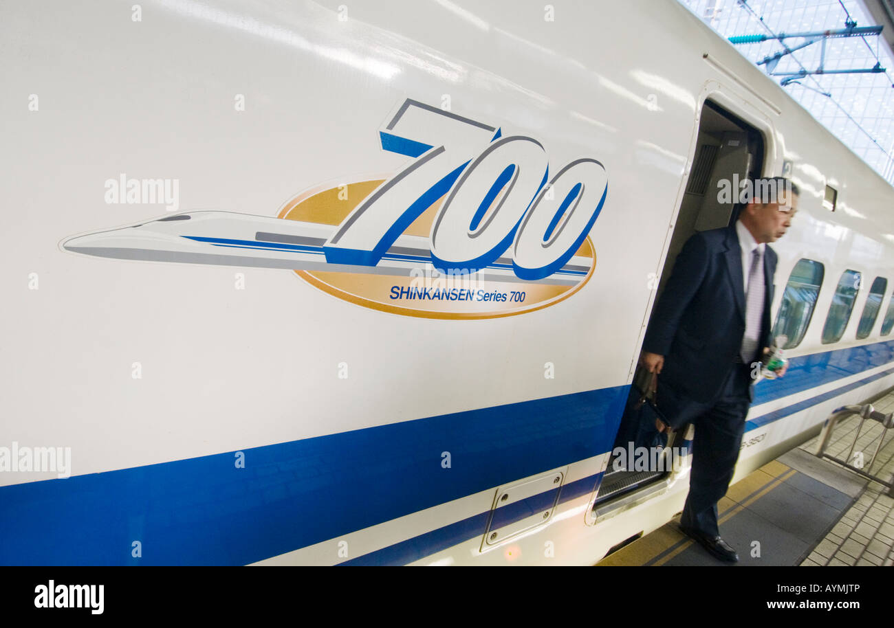 "A Japanese businessman disembarks from the new 700 series shinkansen ...
