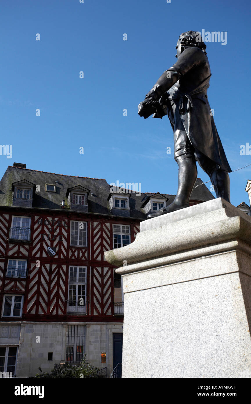Medieval houses in Place du Champ Jacquet with statue of Leperdit ...