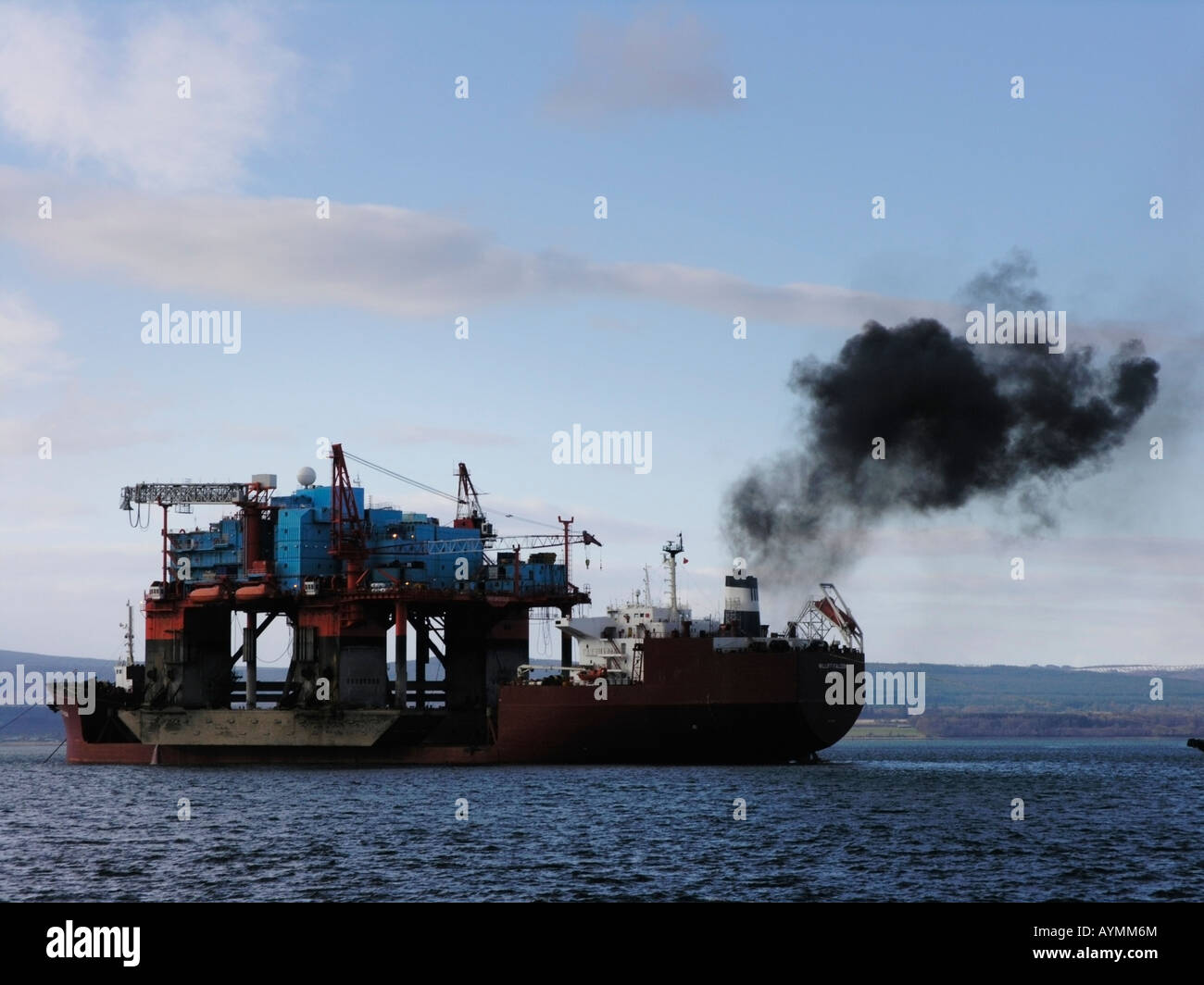 Crane barge transporter at moorings in Cromarty Firth with exhaust ...