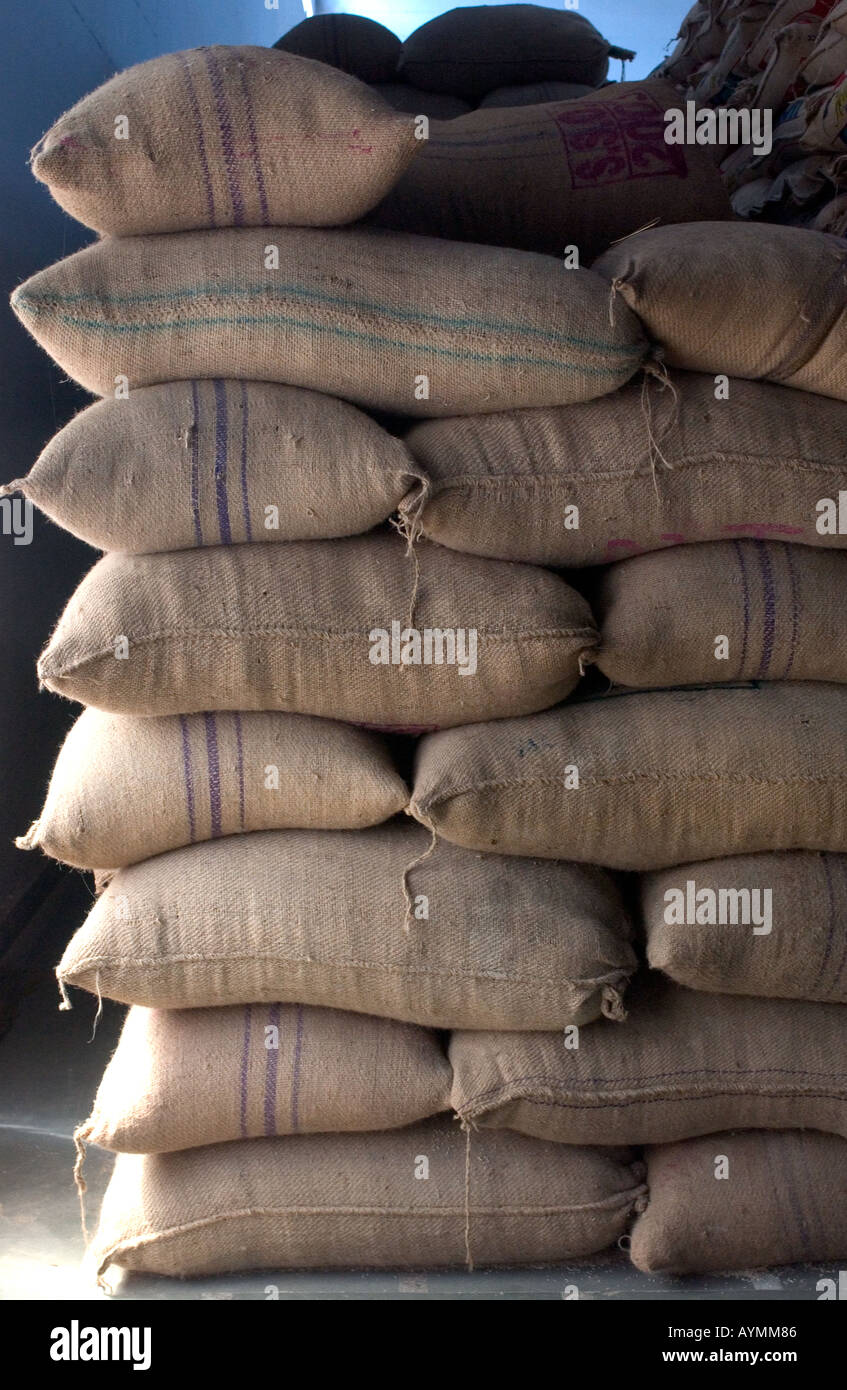 Rice sacks stacked in a pile in a rice processing plant Stock Photo - Alamy