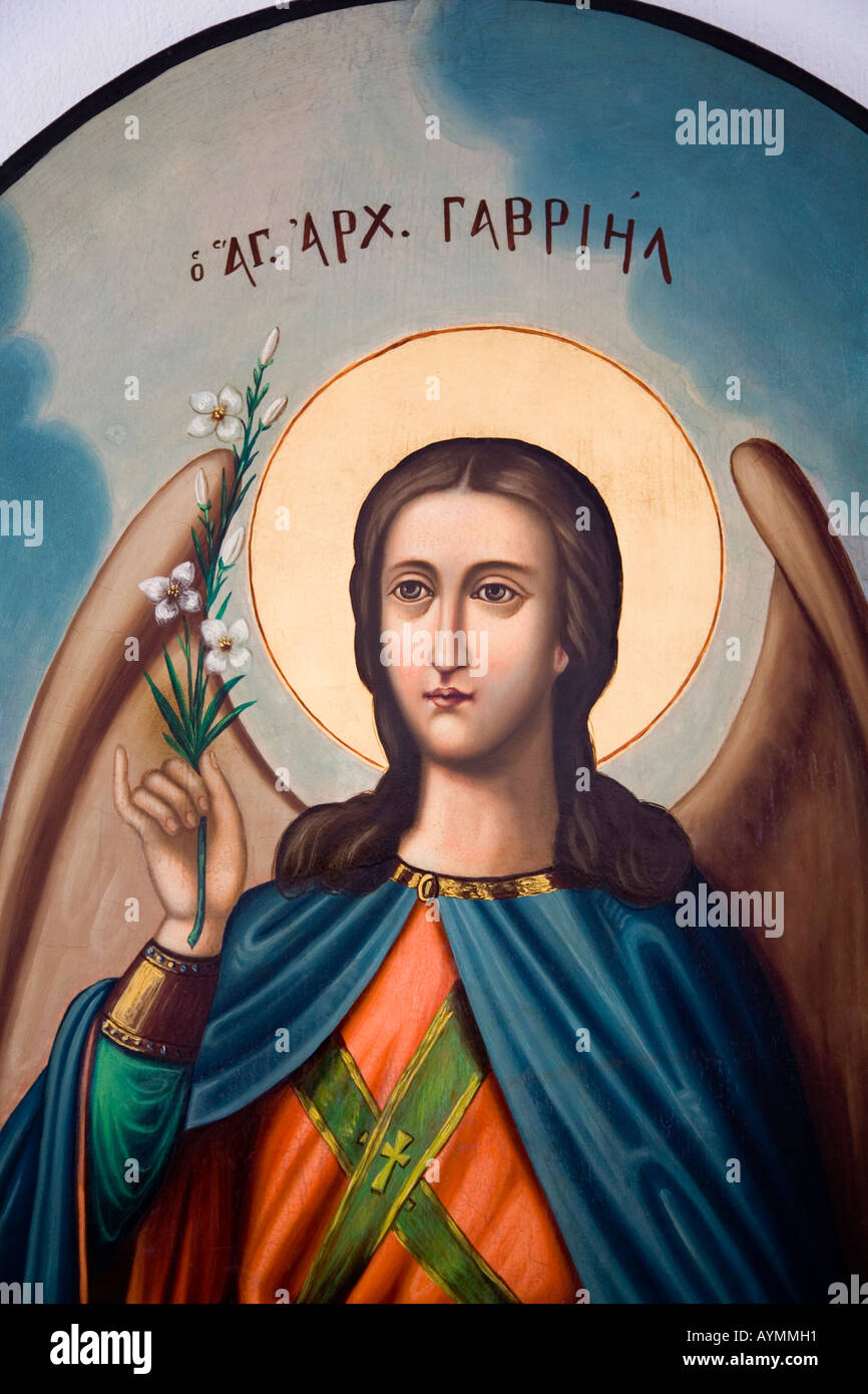 The Annunciation. Archangel Gabriel is offering a white lilly flower to ...