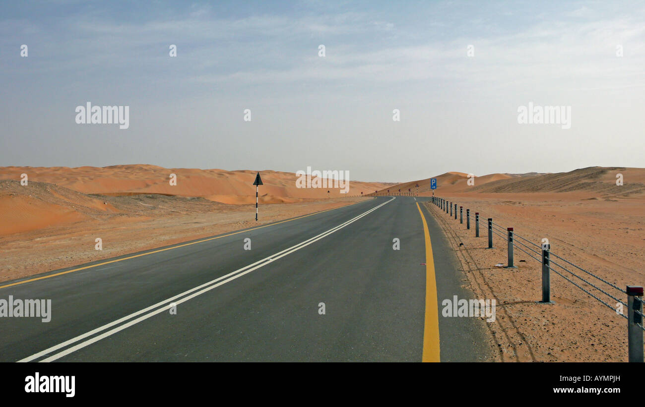 A desert road through the Liwa Oasis in the Western Region of Abu Dhabi ...