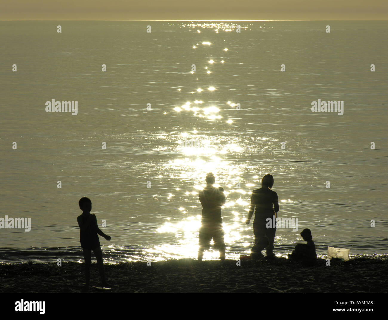 Happy family beach behind hi-res stock photography and images - Alamy