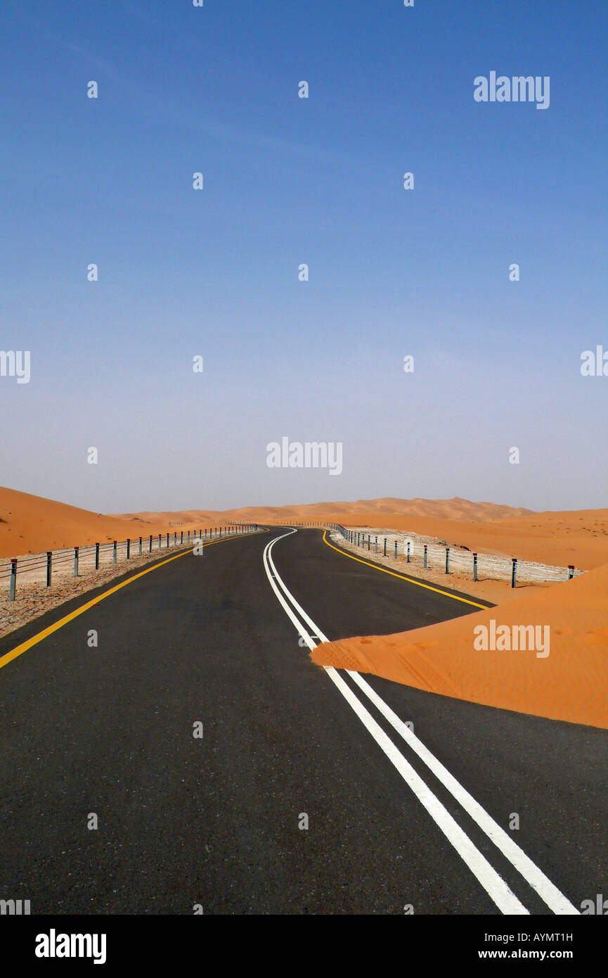 A desert road through the Liwa Oasis in the Western Region of Abu Dhabi ...