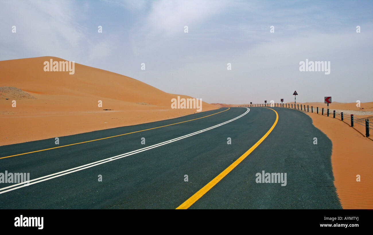 A desert road through the Liwa Oasis in the Western Region of Abu Dhabi ...
