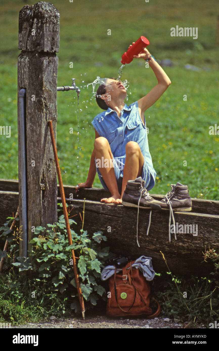 Child pouring water into a bottle hi-res stock photography and images ...