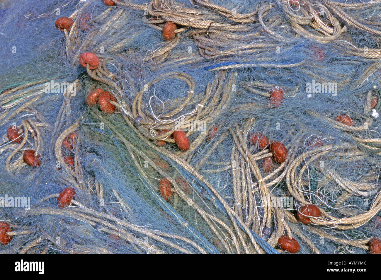 Piled up fishing net with floats on headline Stock Photo - Alamy