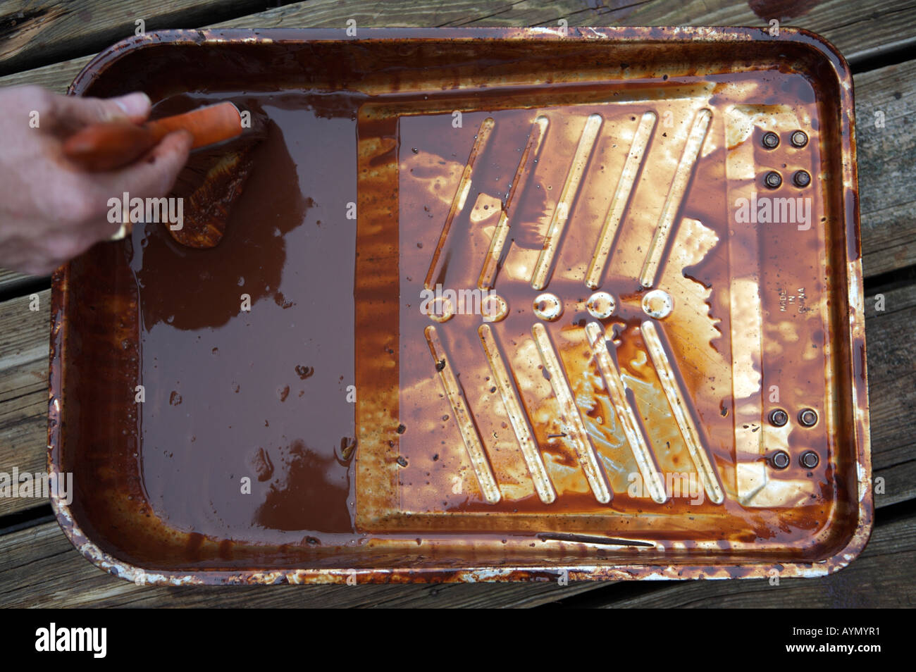 Hand reaching paint bucket with brown paint Stock Photo - Alamy