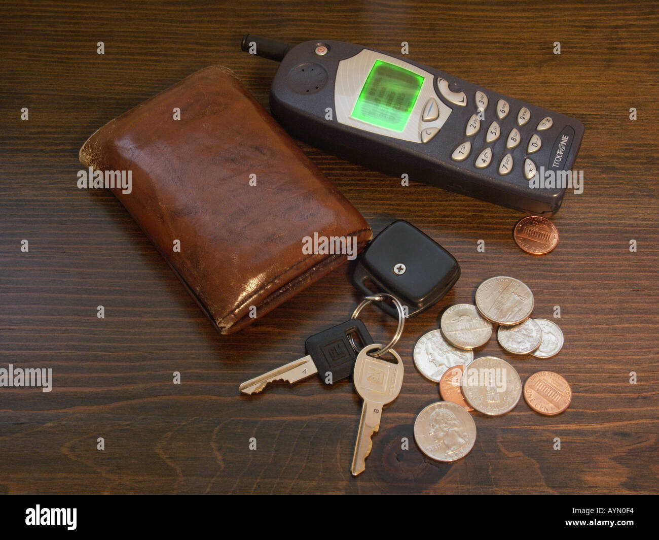 Wallet, keys, change and a cell phone on dresser top Stock Photo - Alamy