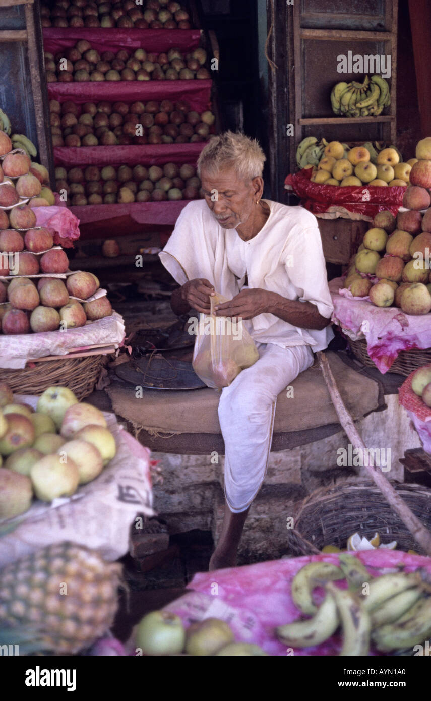 Vertical environmental portrait of an Indian man crippled with one leg ...