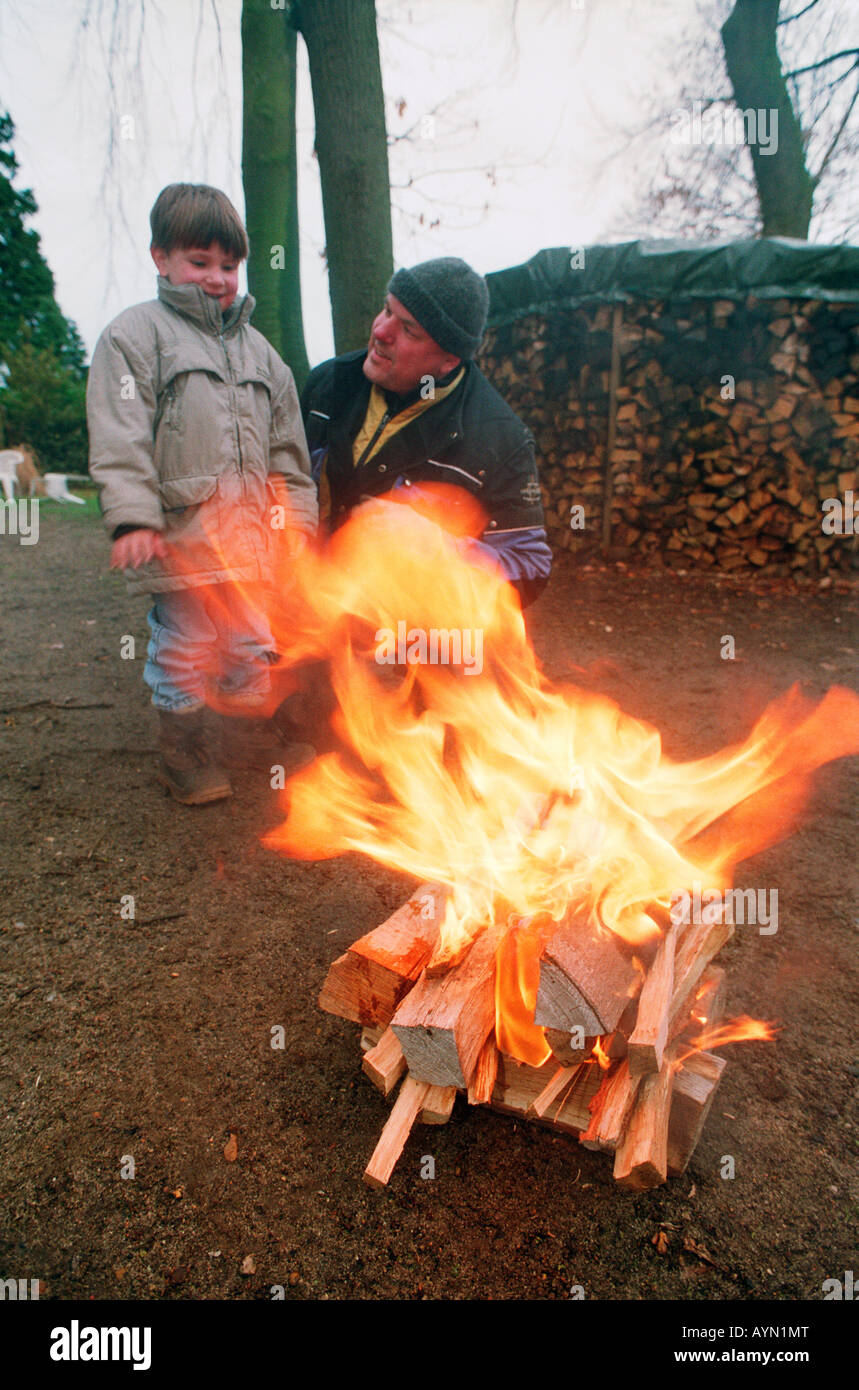 Father and son making fire Stock Photo - Alamy
