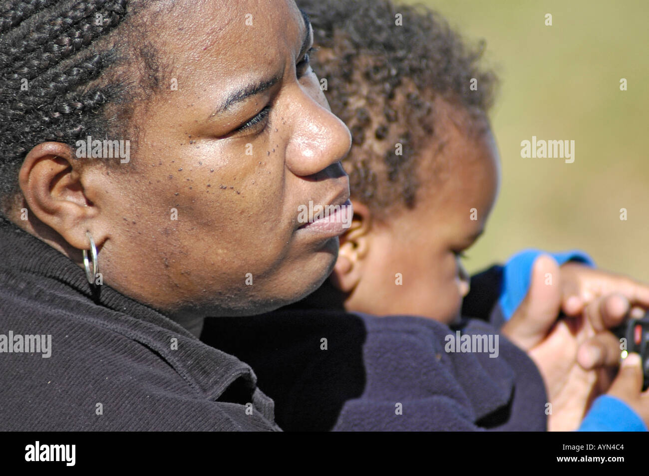 Mother and her young toddler son struggling her with mole and skin ...